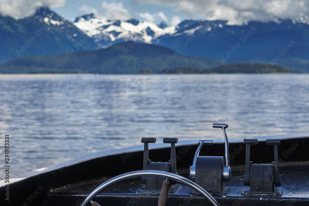 Small boat is approaching a glacier. Wheel of the vessel is in focus ...