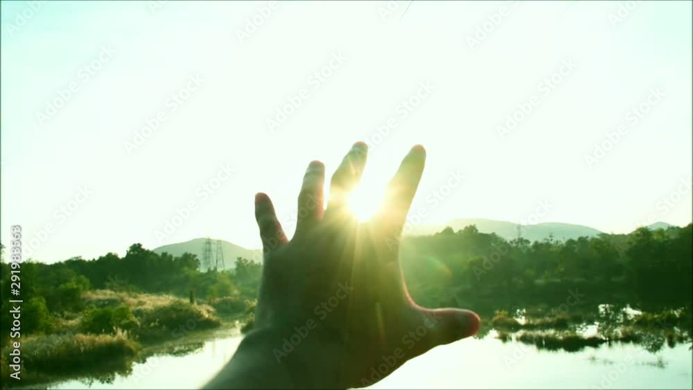 Use hand to touch the light of sunrise, Beautiful sun rise in winter ...