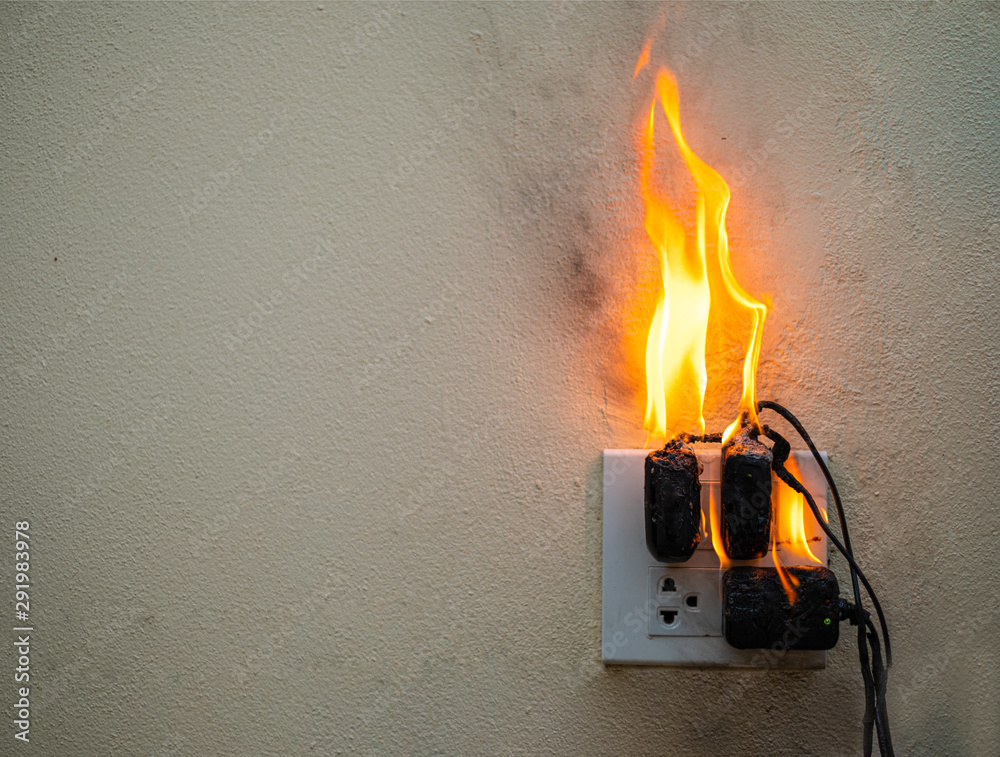 On fire adapter at plug Receptacle on white background Stock Photo ...