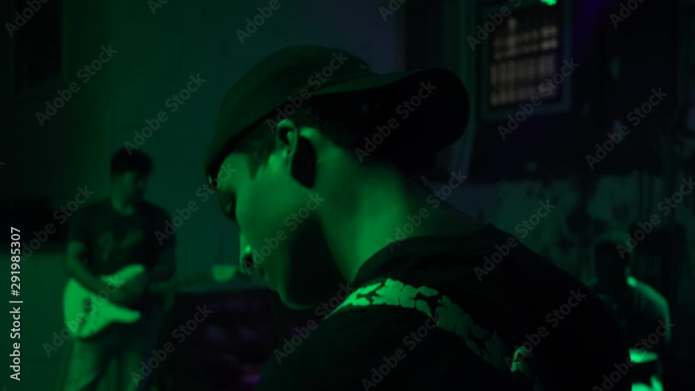 A guitarist rocking out while performing alongside an independent ...