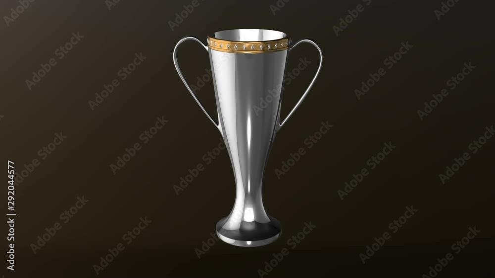 Silver trophy cup with gold plated ornaments rotating on dark ...