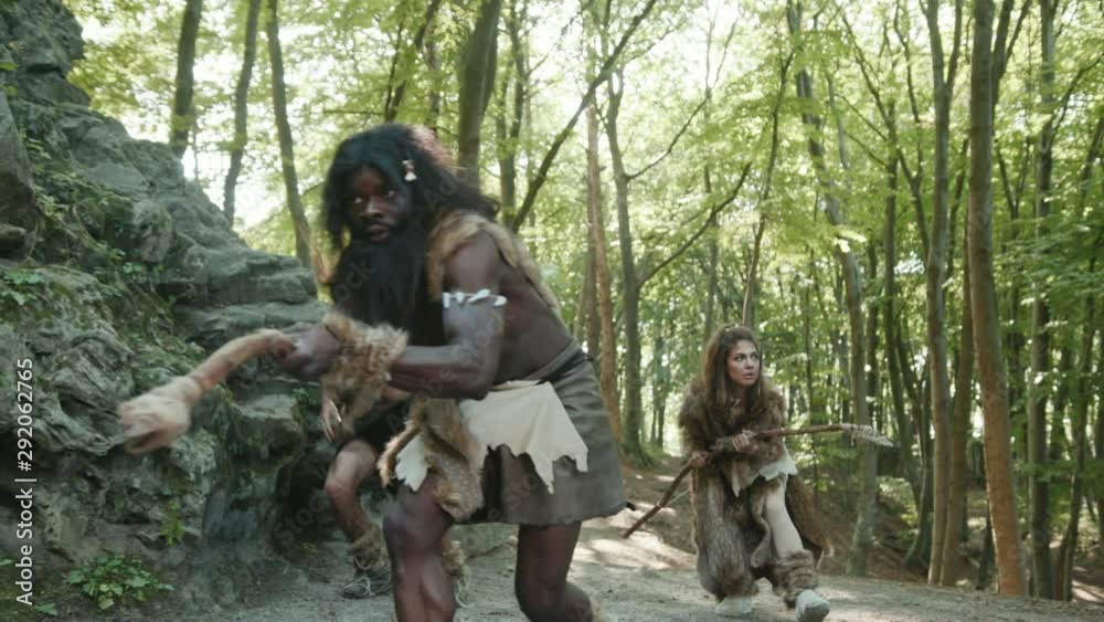 Paleolithic nenaderthals family of hunter-gatherers hunting animals for ...