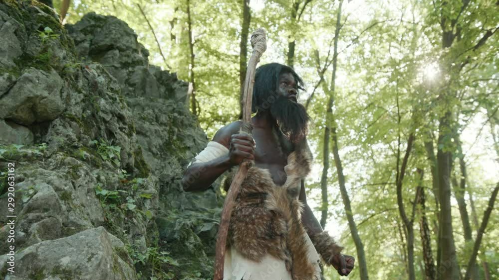 Prehistoric afro tarzan wildman of hunter-gatherers tribe in rocks ...