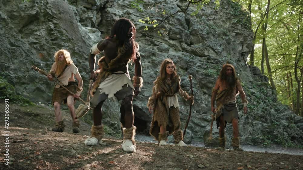 Ancient neanderthal family of hunter-gatherers exploring jungle ...