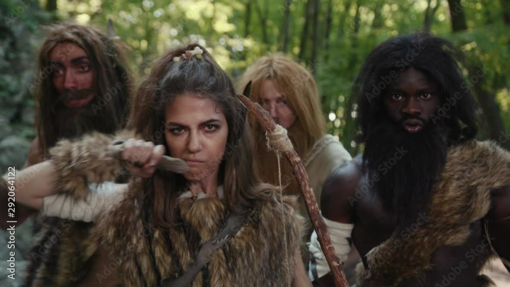 Neanderthal tribe of wild savage people with woman leader growling ...