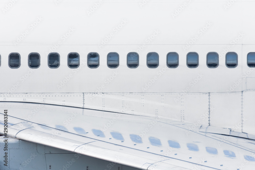 View of the fuselage of the aircraft and many windows, with reflection ...