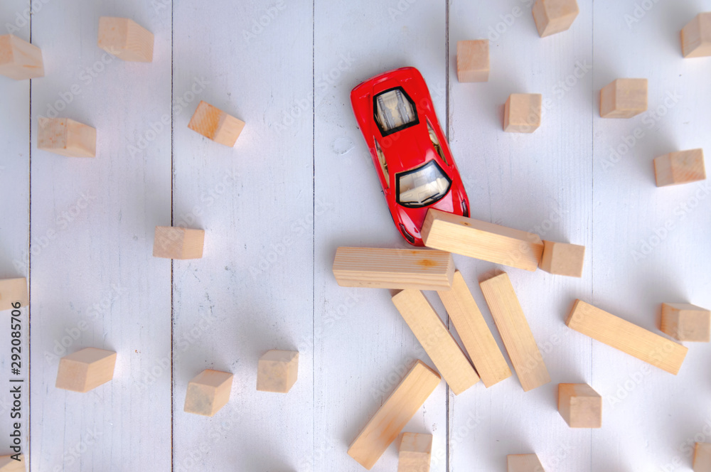 The red toy car overcomes all obstacles in the way and barriers ...