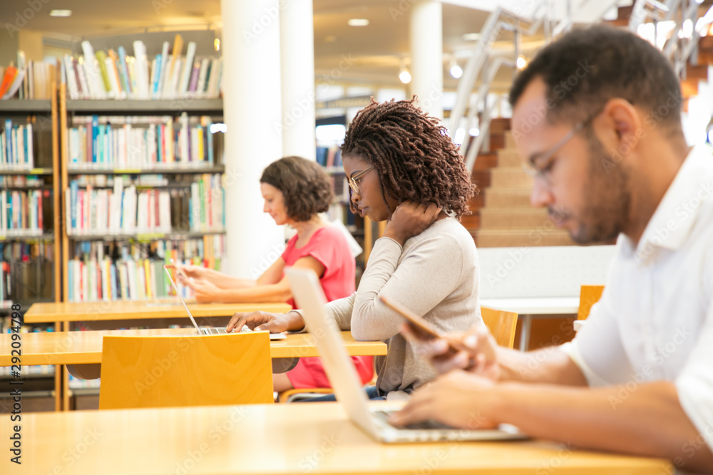 Multiethnic trainees taking online tests in computer class. People ...