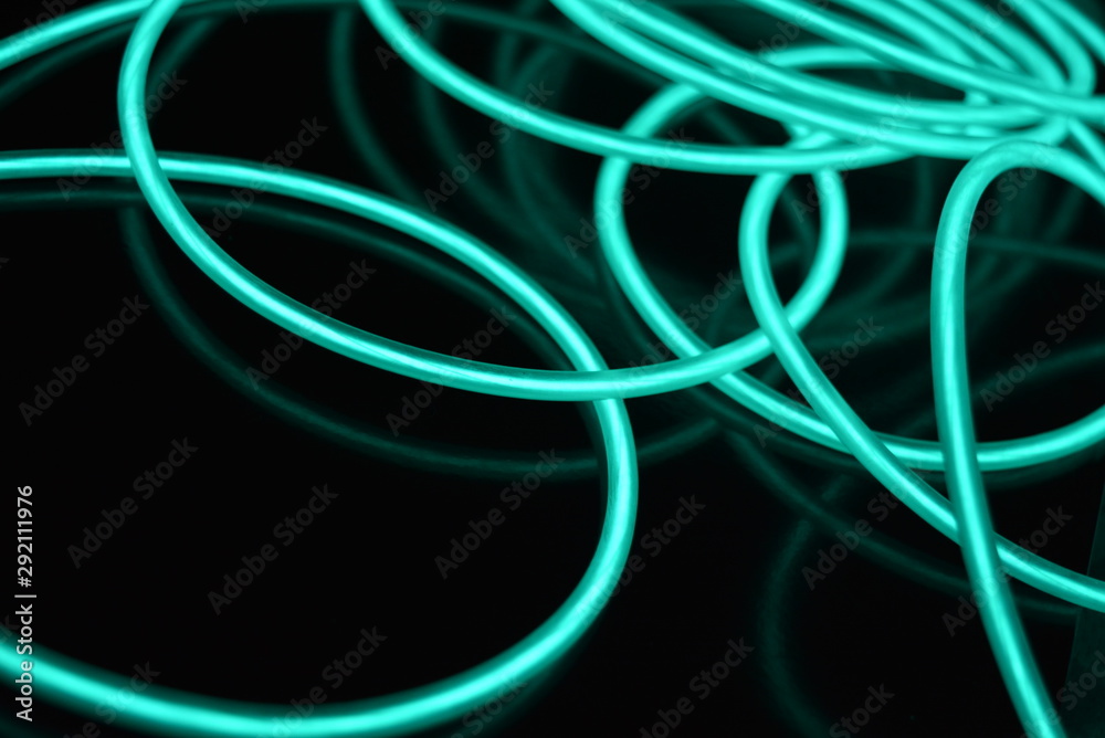 Unusual bright wires made of turquoise-colored material glowing at ...