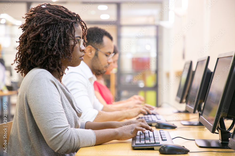 Diverse group of employees working on their computers. Row of man and ...