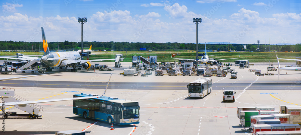 Modern passenger airplane parked to terminal building gate at airside ...