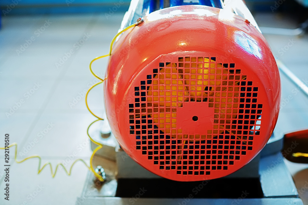 Red electric motor close-up with ground wires. Installation of ...