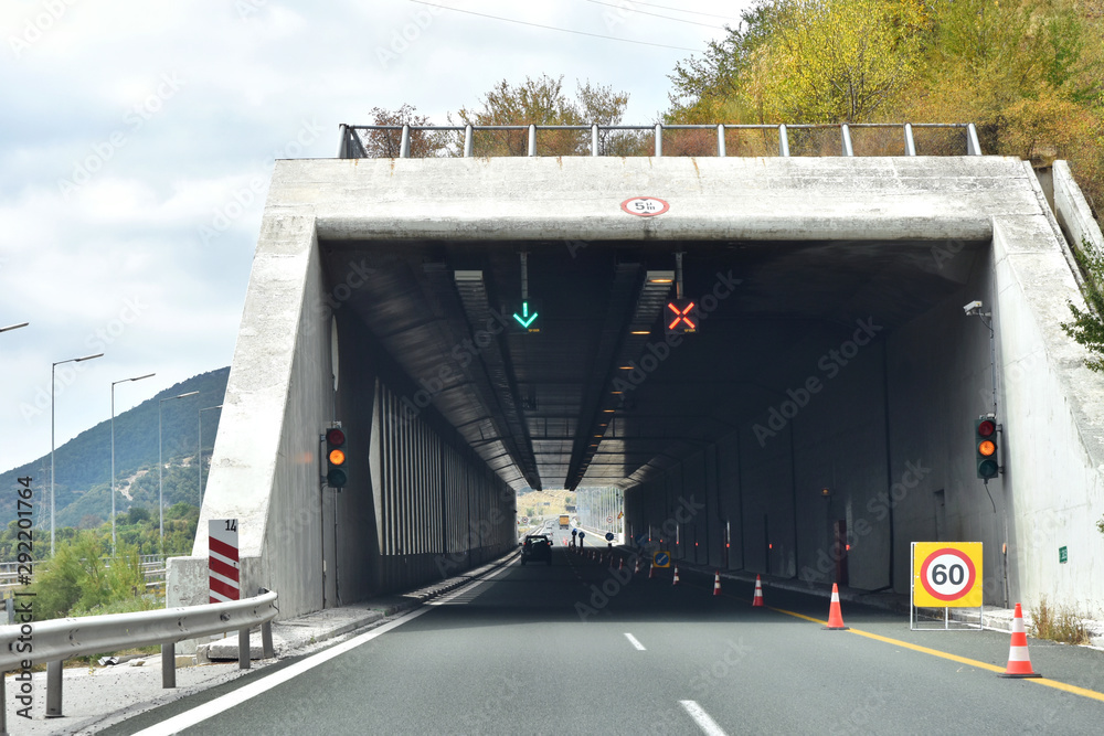 Road tunnel in mountains. Mountain road tunnel with luminous safety ...