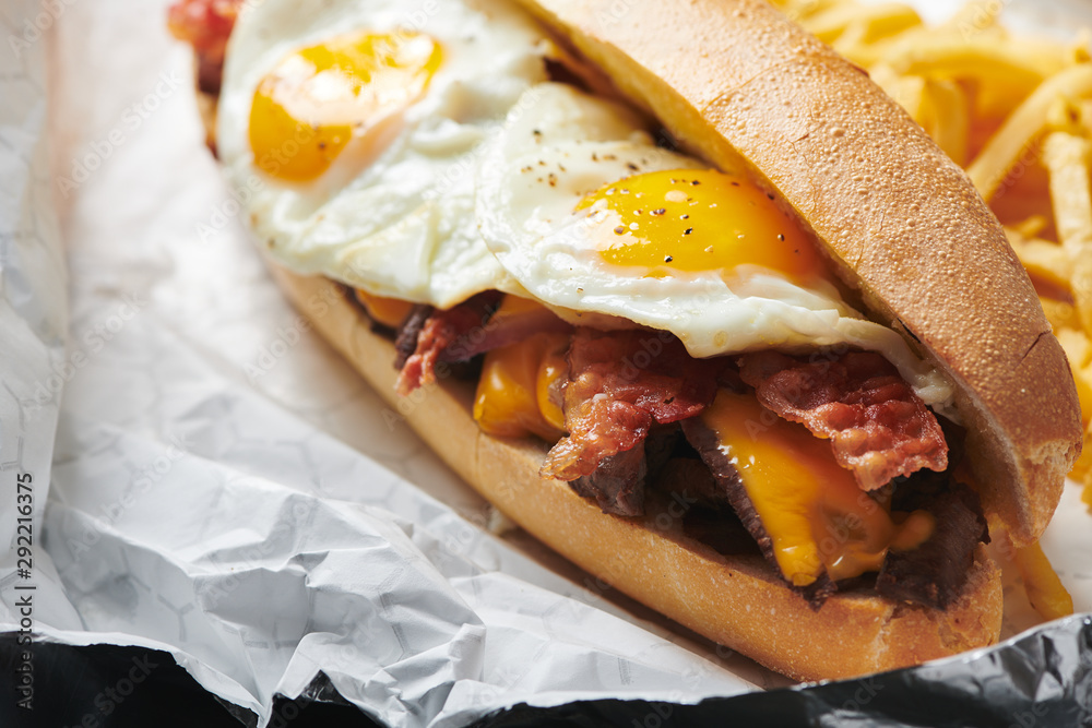 Breakfast Philly Cheesesteak on Parchment with French Fries Stock Photo ...