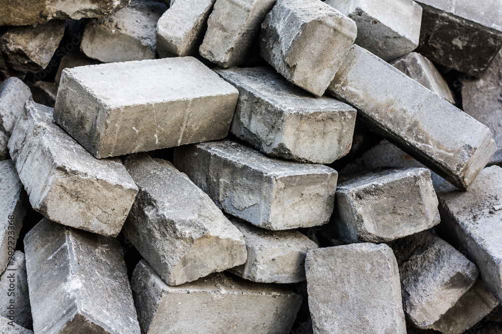 Pile of disassemble gray concrete bricks. close-up of scattered stone ...