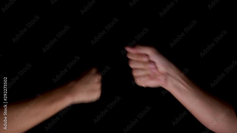Slow motion shot of two hands coming together in a secret handshake in ...