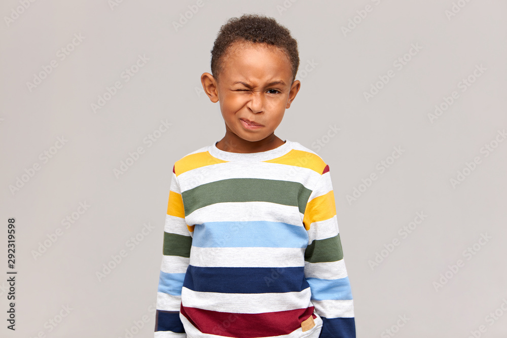 Moody dissatisfied black dark skinned boy showing his bad temper ...