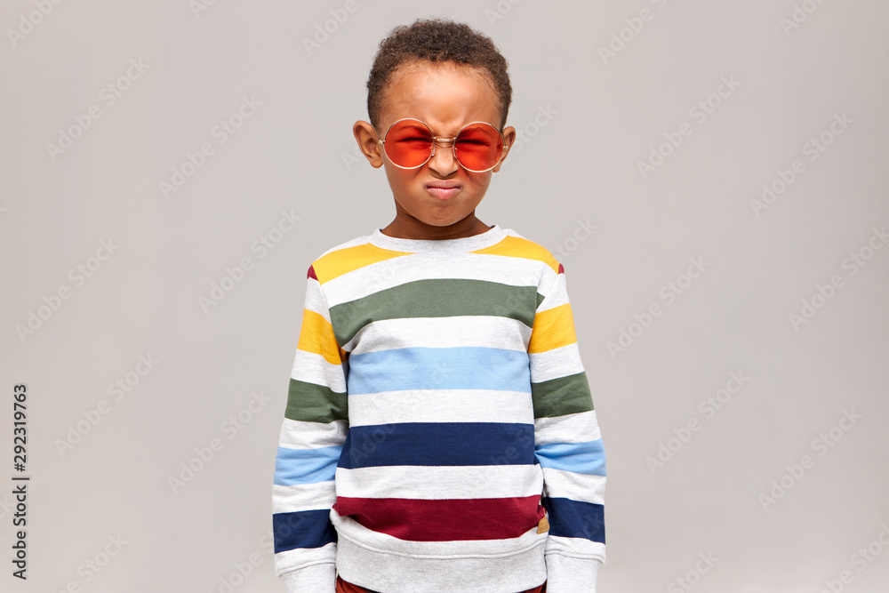 Picture of stubborn Afro American kid in stylish sweater and pink ...