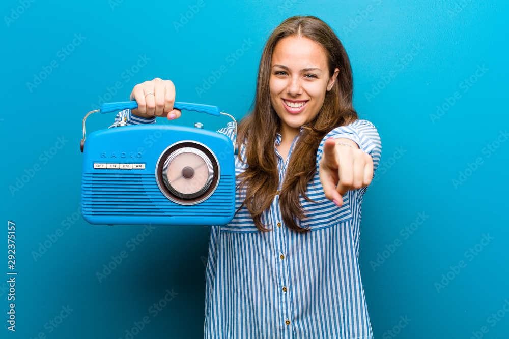 young woman with a vintage radio against blue background Stock Photo ...
