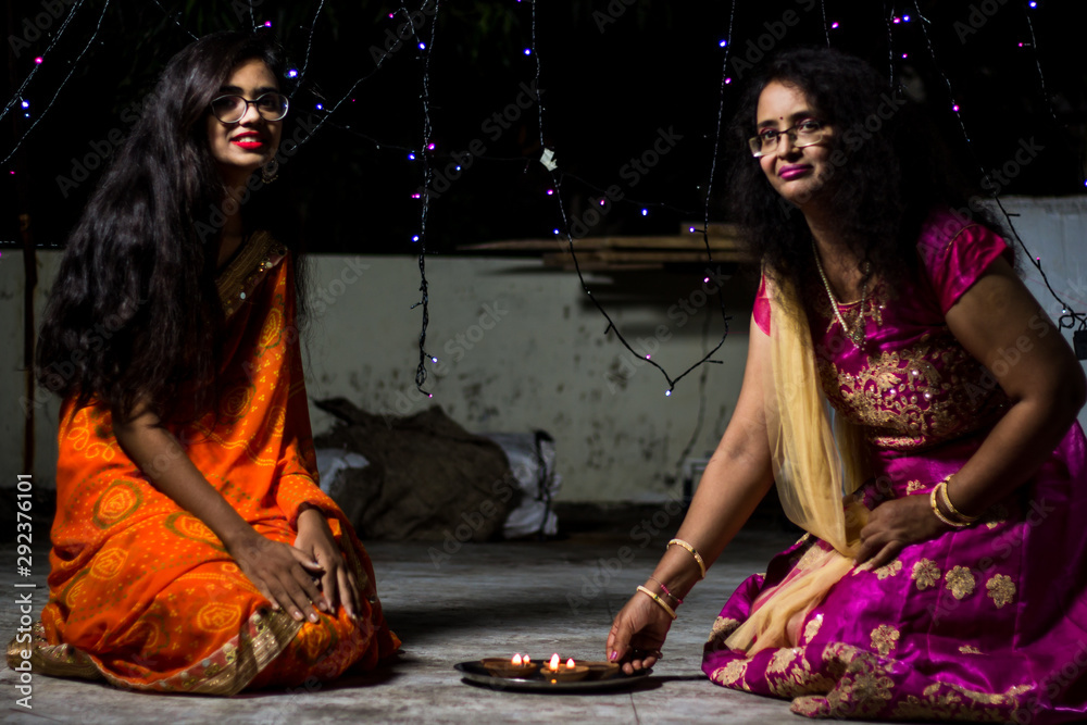 Woman and teenager girl celebrating diwali. Diwali is biggest festival ...