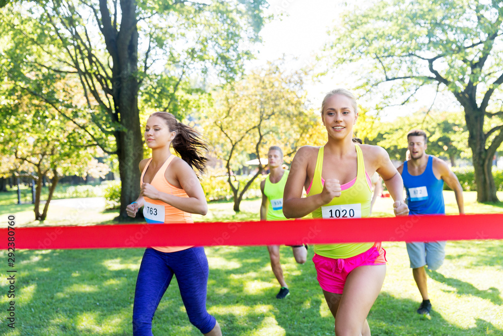 fitness, sport and success concept - happy woman winning race and ...