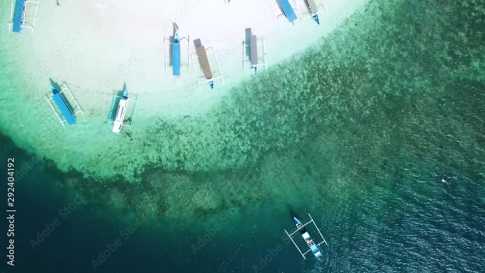 Top down view of turquoise water and tourism boats on the Gili Kedis ...