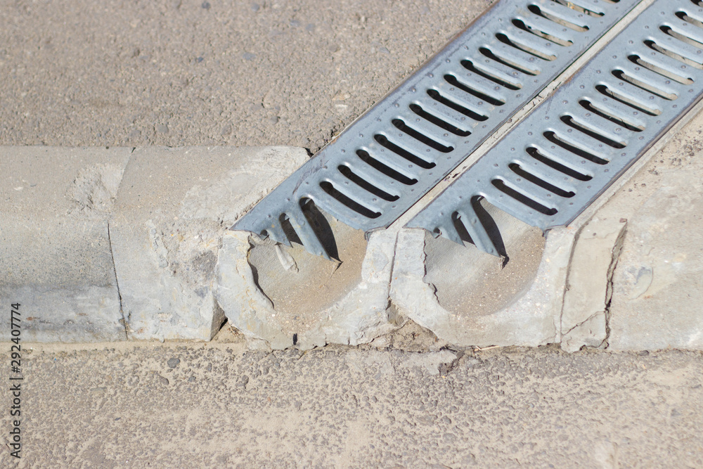 Drainage grating for drain of rain water. two gutters of the drainage ...