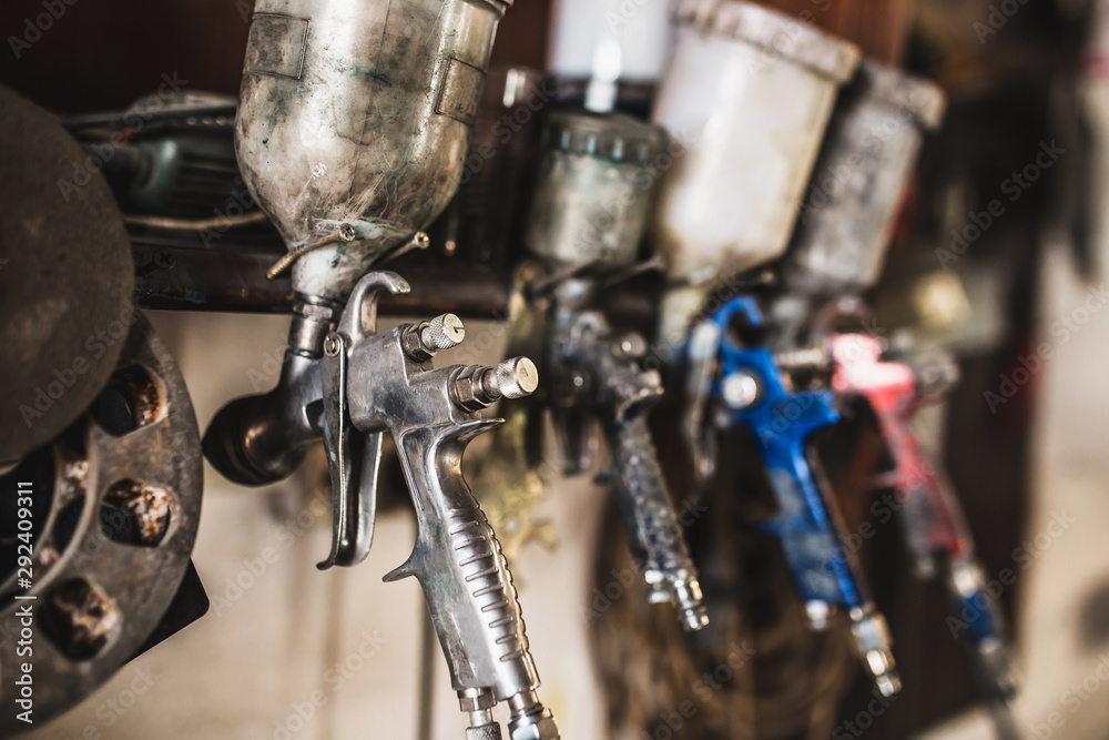 Paint spray guns in a spray booth - auto repair shop Stock Photo ...