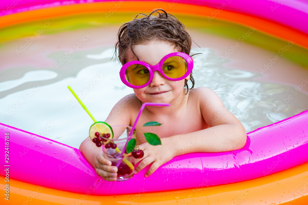 Happy child having fun at swimming pool on sunny day. Summer vacation ...