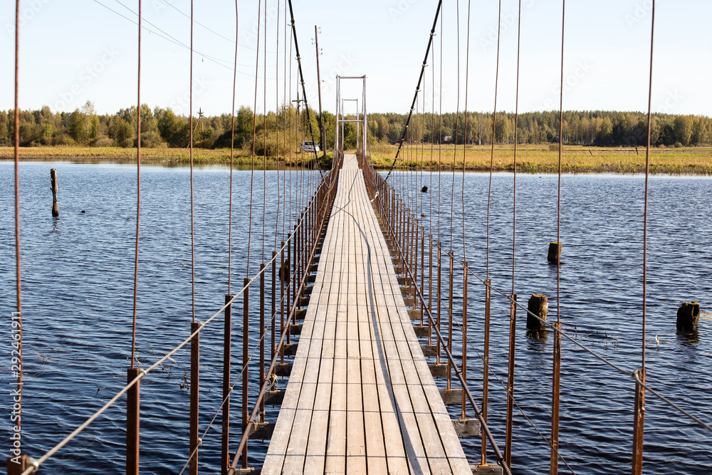 Suspension bridge across the river Tsna in the village Asviha Tver region Russia Stock Photo ...