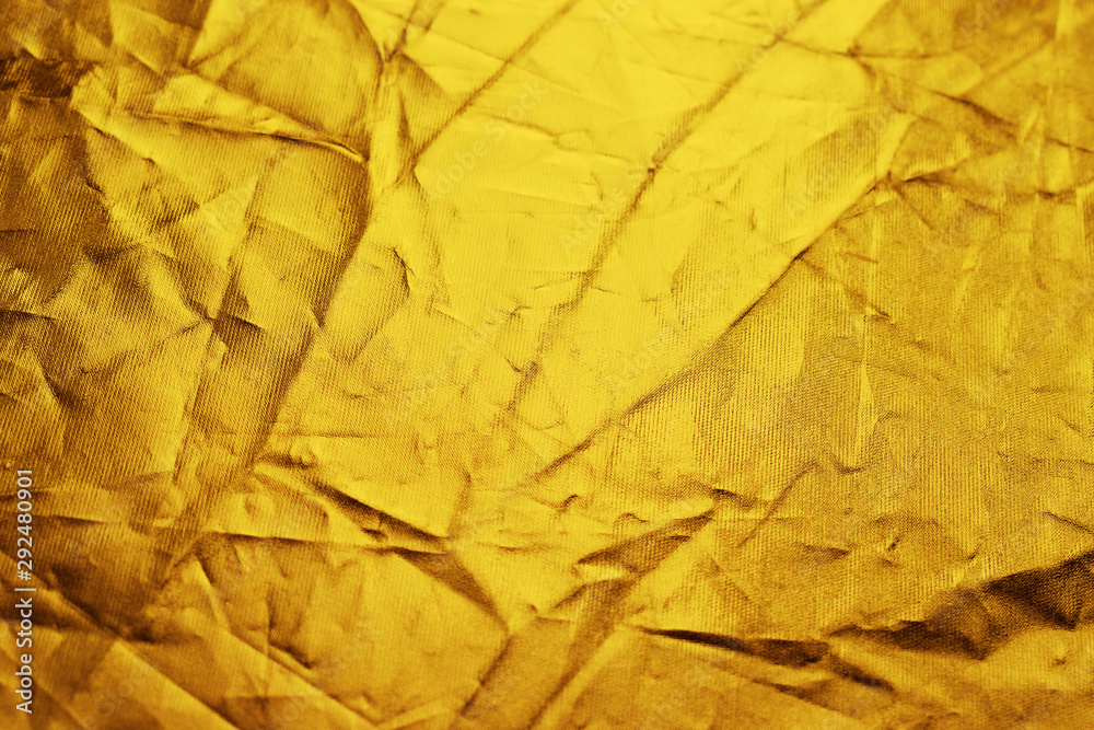 Golden color wrinkled fabric reflector background. Crumpled creasy gold ...