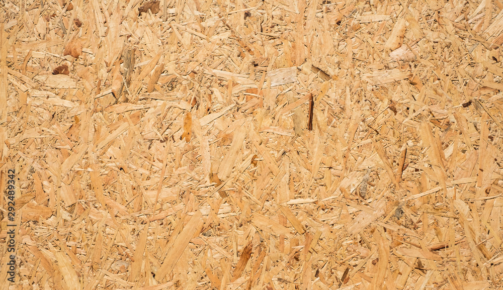 OSB boards are made of brown wood chips sanded into a wooden background ...
