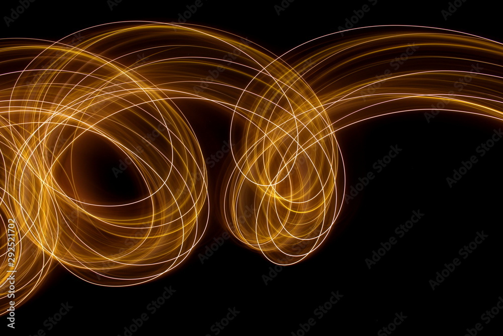 Long exposure photograph of metallic gold neon colour in an abstract ...