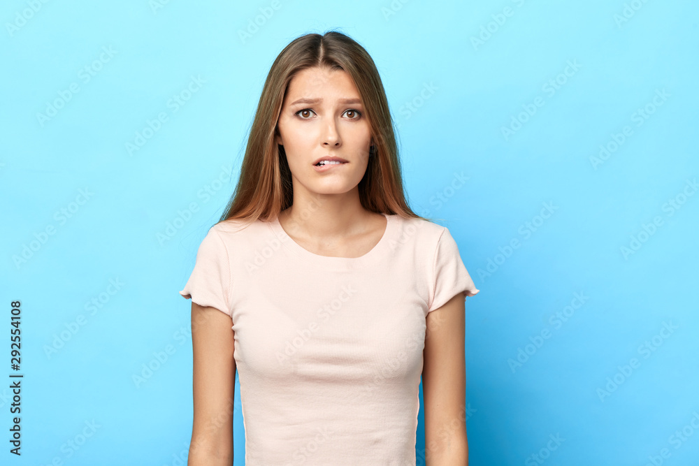 Shy and timidyoung woman with long brown hair having indecisive ...