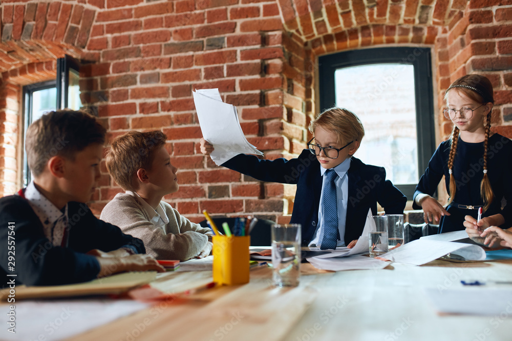 arrogant angry unhappy boss showing documants to hois colleagues ...