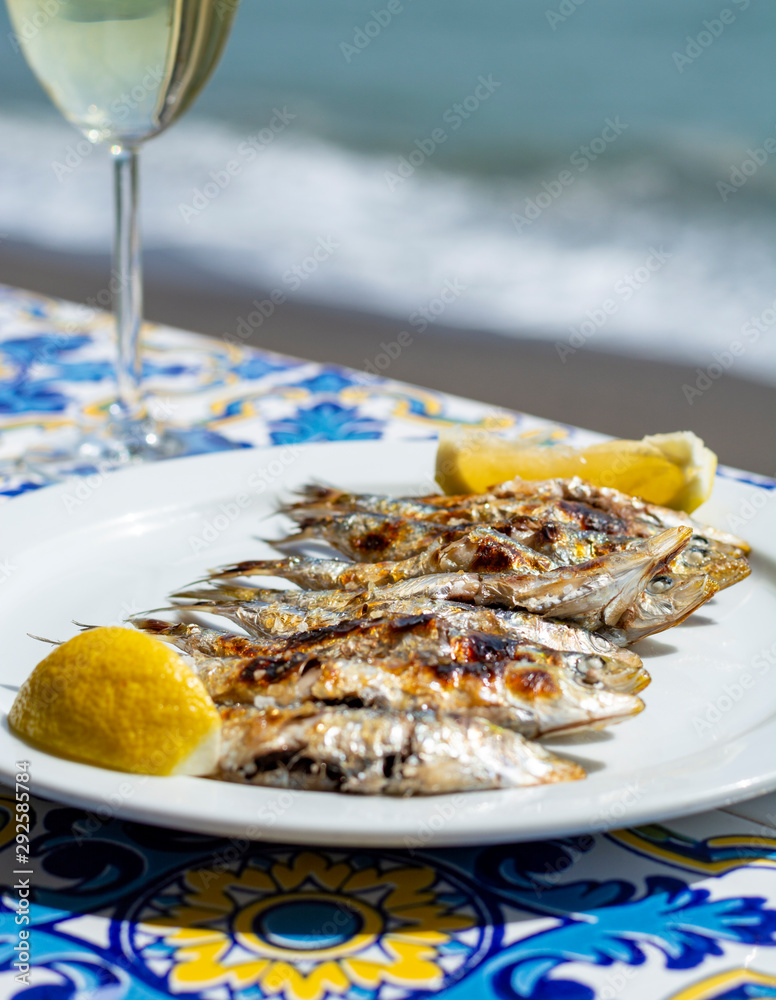 Espeto, Malaga style fish on stick barbecue prepared on olive tree ...