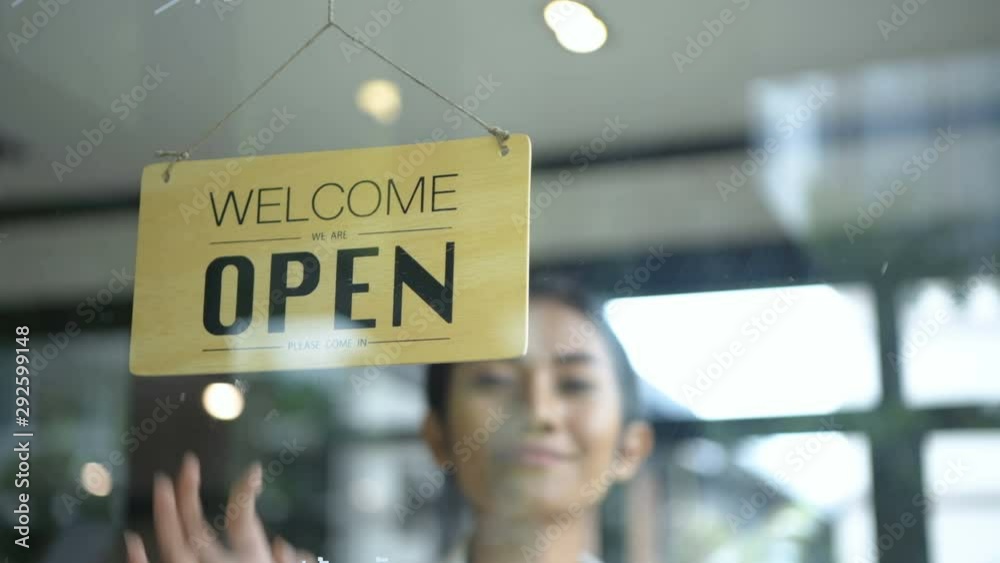 Coffee shop concept. A female employee is rolling over the coffee shop ...