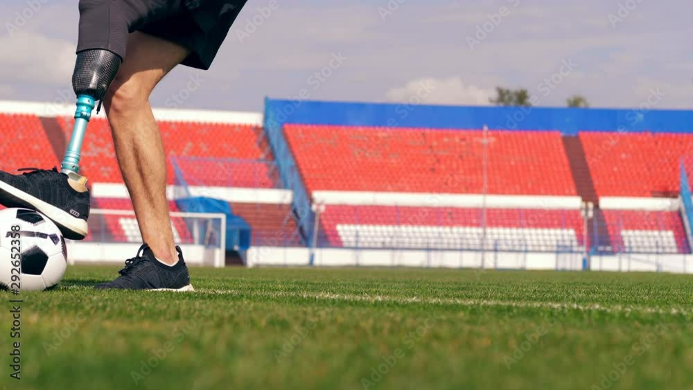 Paralympian with a bionic leg is training with a football Stock ビデオ ...