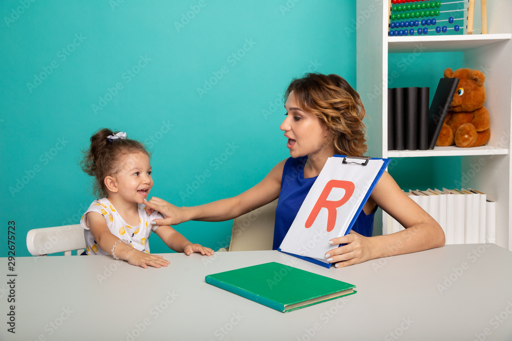 Speech therapy concept. Kid with therapist learning letters together ...