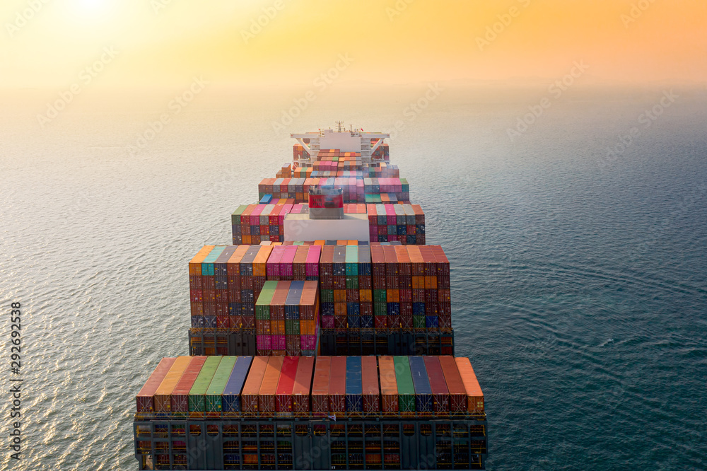 top aerial view of the large volume of TEU containers on ship sailing ...