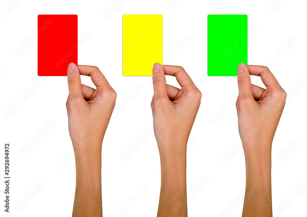 Hand holding a red card, a yellow card, a green card on a white ...