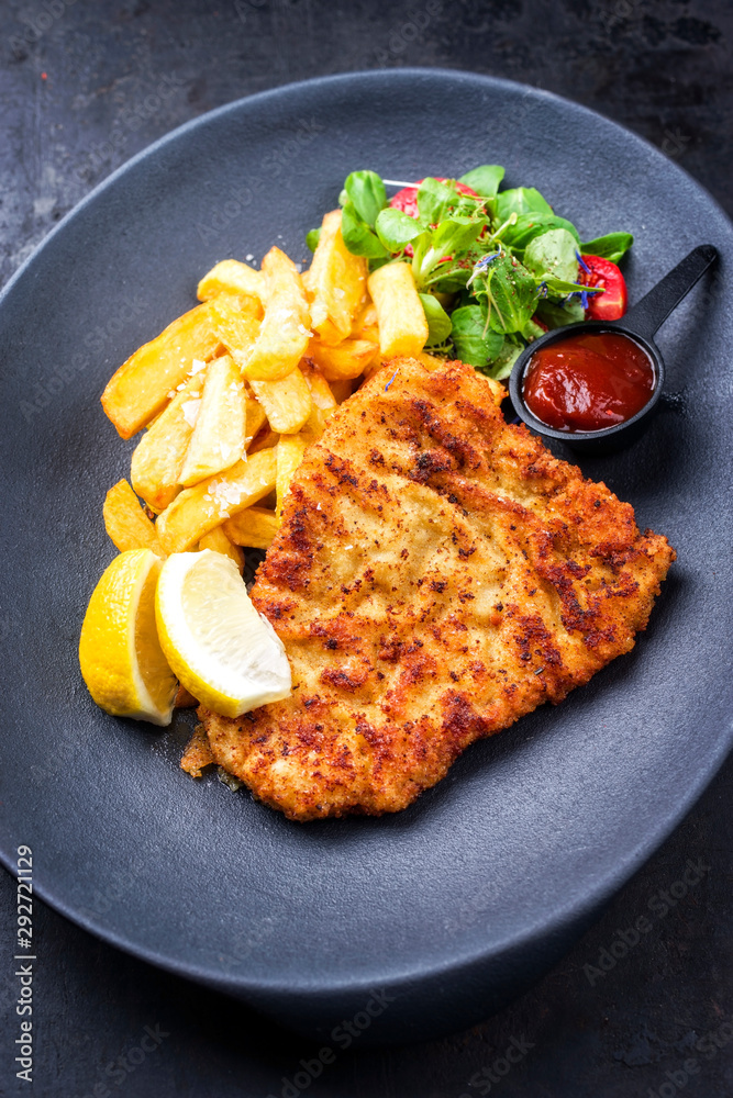 Deep fried Wiener schnitzel from veal topside with French fries and ...