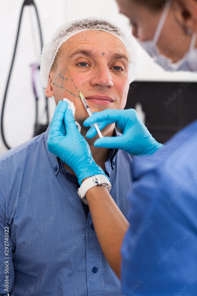 Female doctor is doing injection to patient in skin of face Stock Photo ...