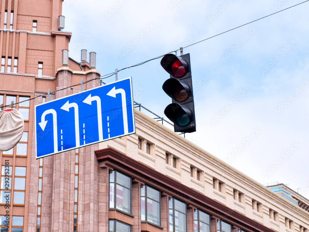 Traffic signs indicating the direction of movement and traffic light ...