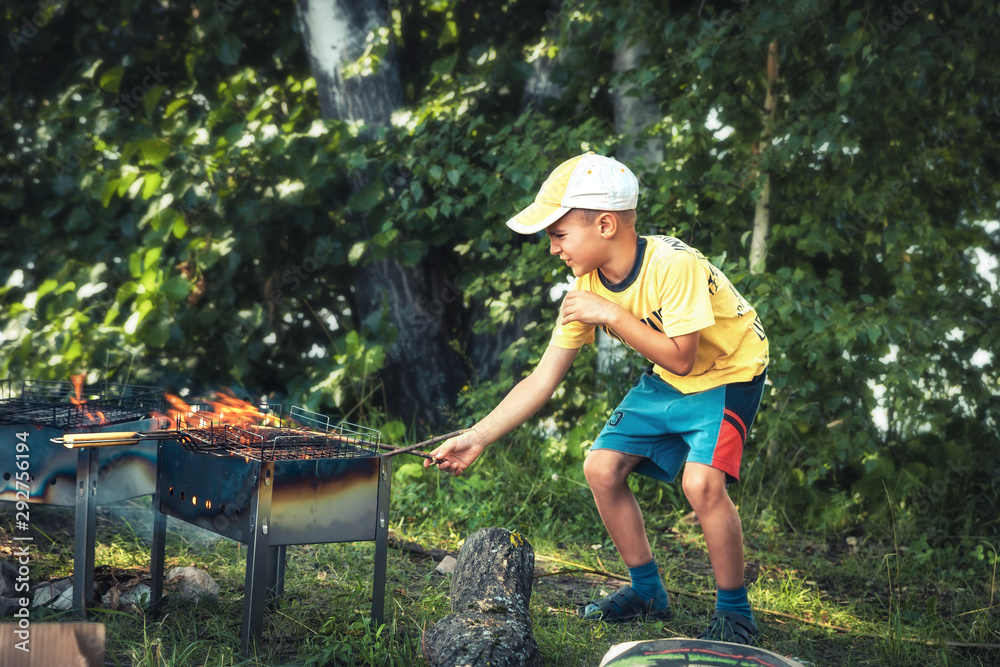 Photo & Art Print mischievous kid boy playing with fire concept fire ...