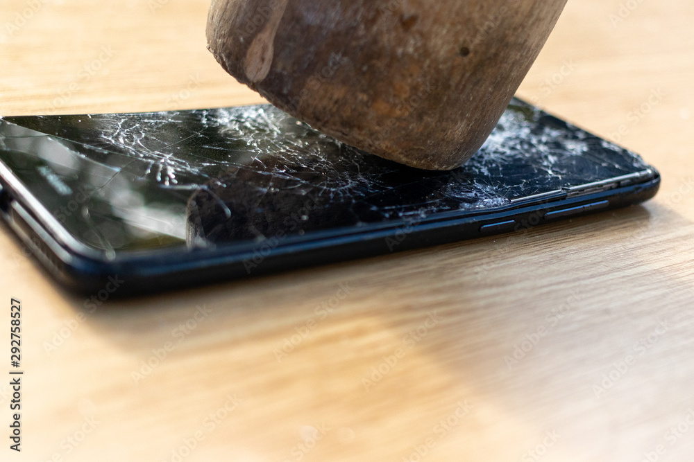 Broken screen cell phone on light background. Old broken black ...