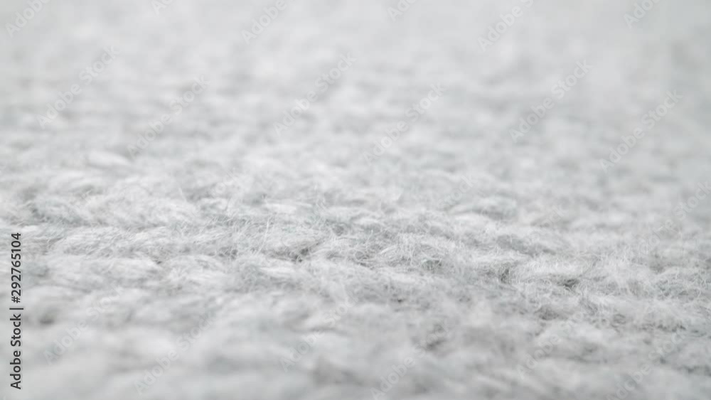 Extreme detail view of sheep wool cloth texture in macro dolly shot ...