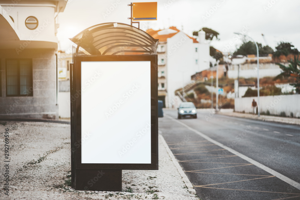 City bus stop with an empty banner mock-up; template of an advertising ...