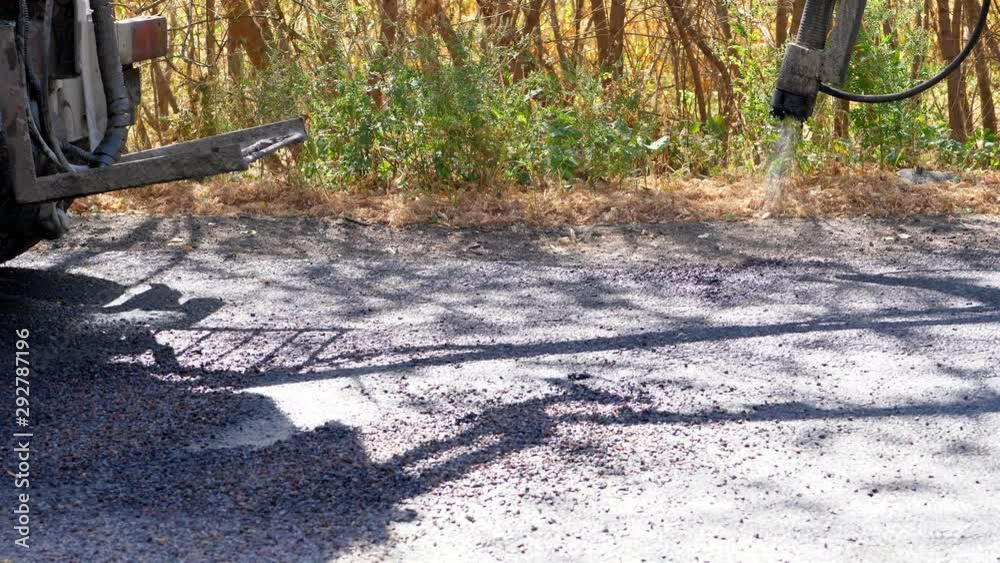fast road surface repair process by asphalt, bitumen spraying. spray ...