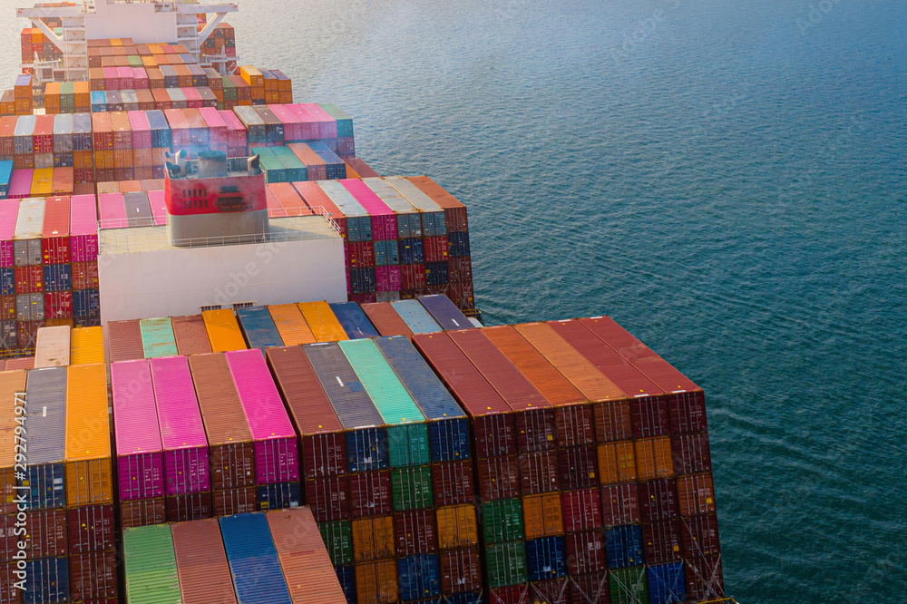 top aerial view of the large volume of TEU containers on ship sailing ...
